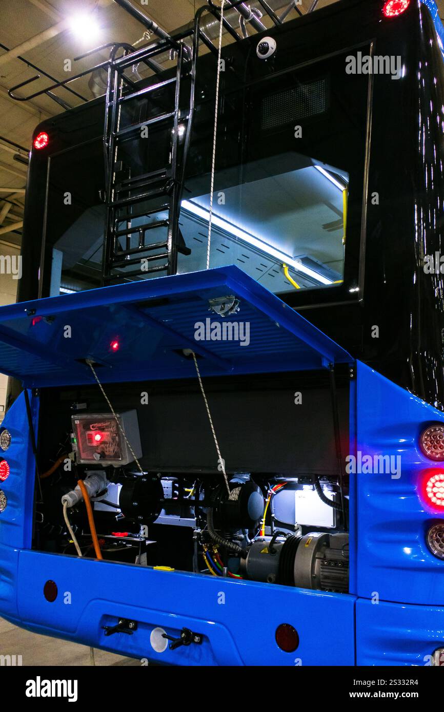 Modern city bus, hybrid model, with emphasis on the rear and open door ...