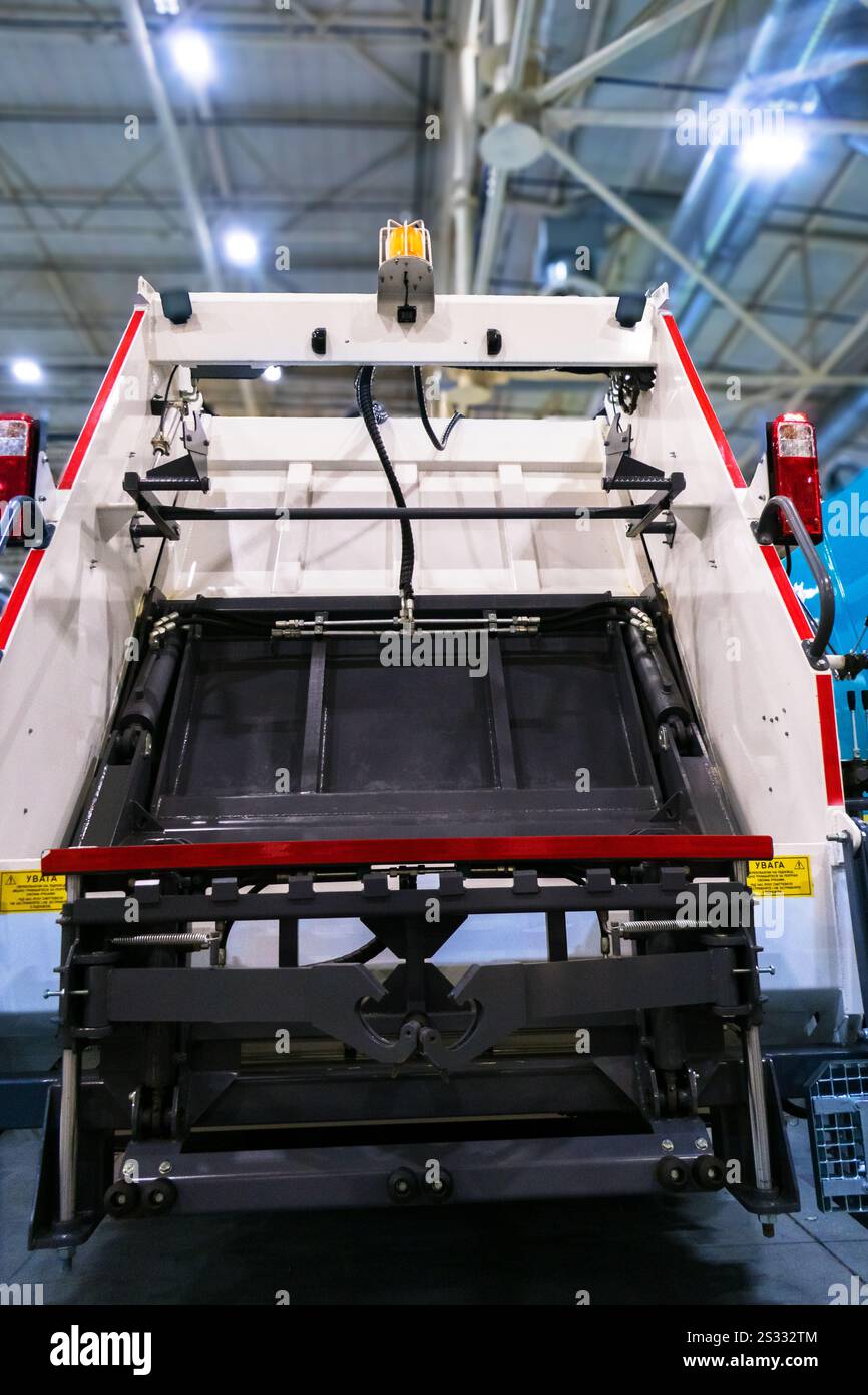 A close-up view of the rear of a garbage truck with the loading ...