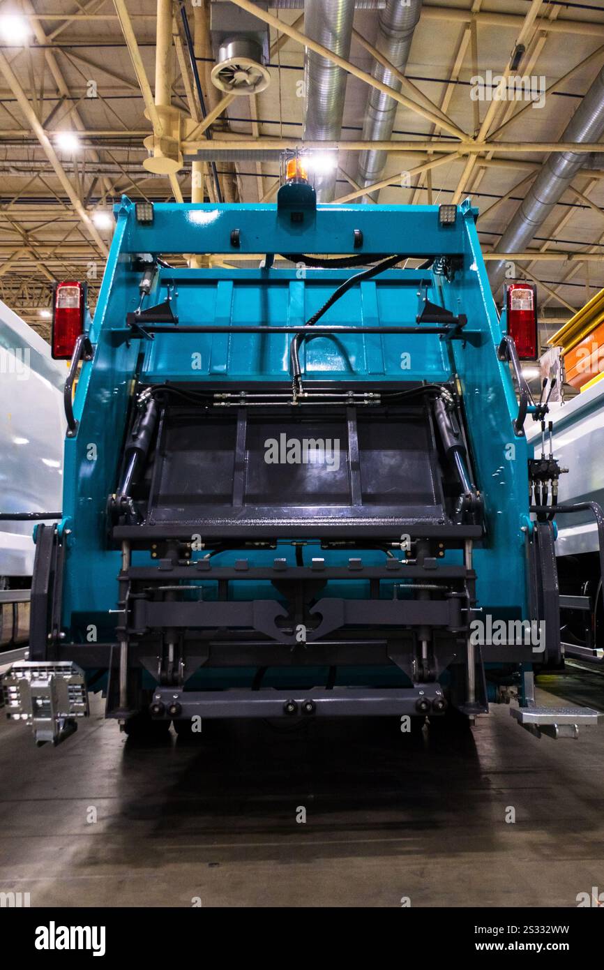 A close-up view of the rear of a garbage truck with the loading ...