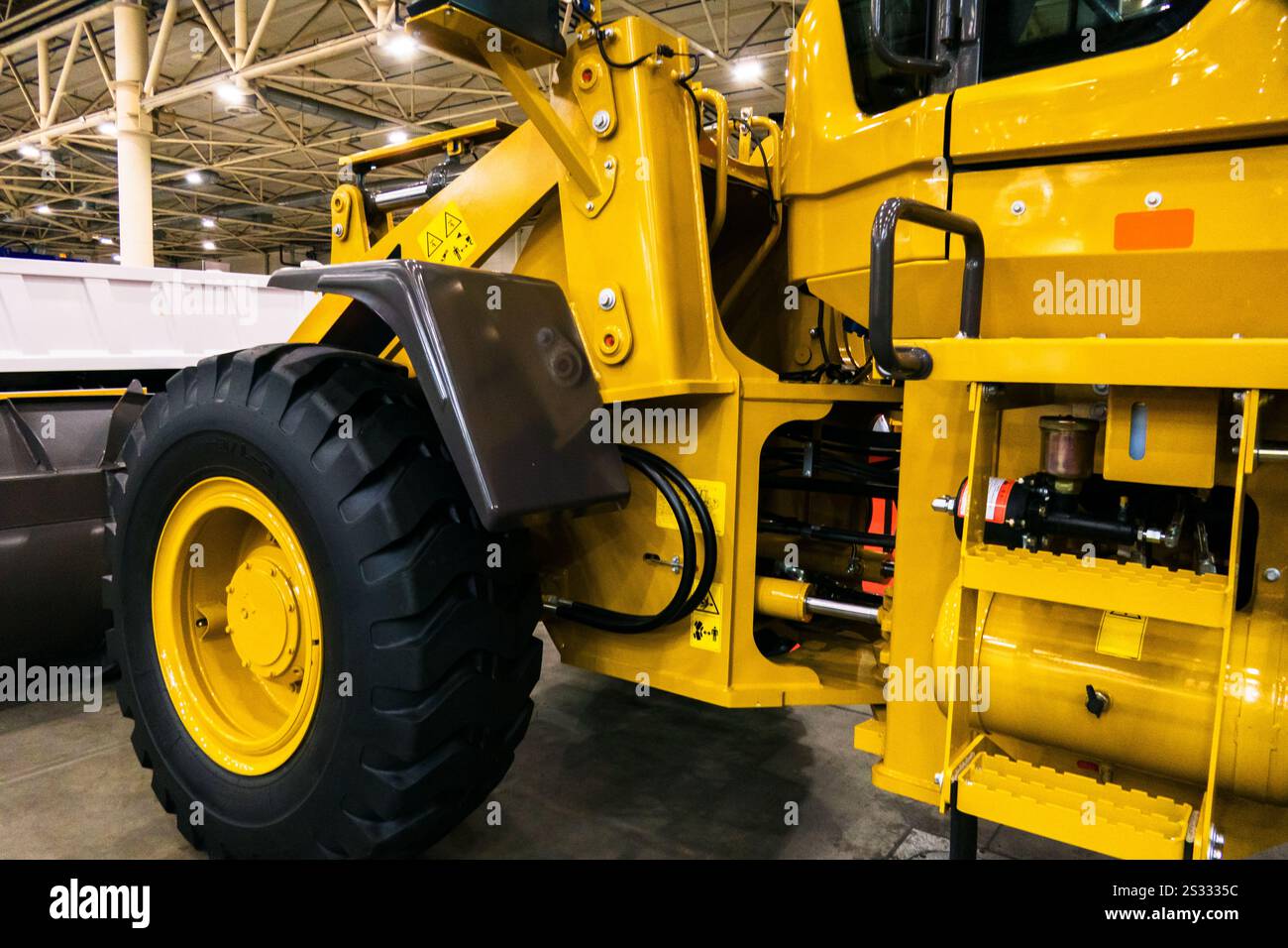 A close-up view of a wheel loader (or front-end loader), focusing on ...
