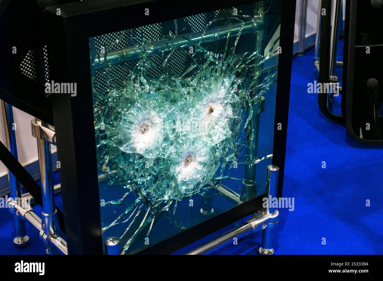 A close-up of bulletproof glass being tested for strength, with visible ...