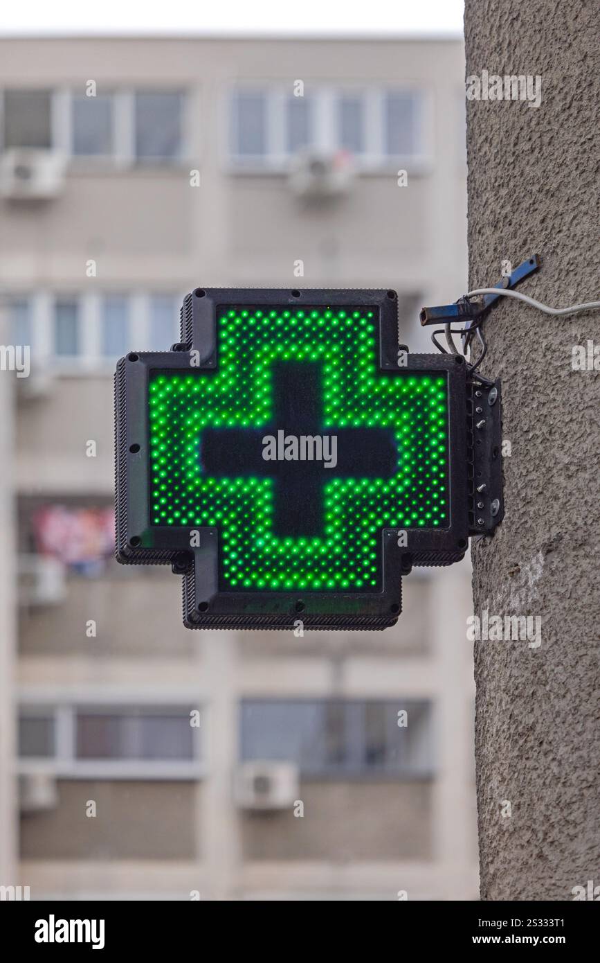 Green Cross Led Lights at Pharmacy Store Corner Stock Photo - Alamy