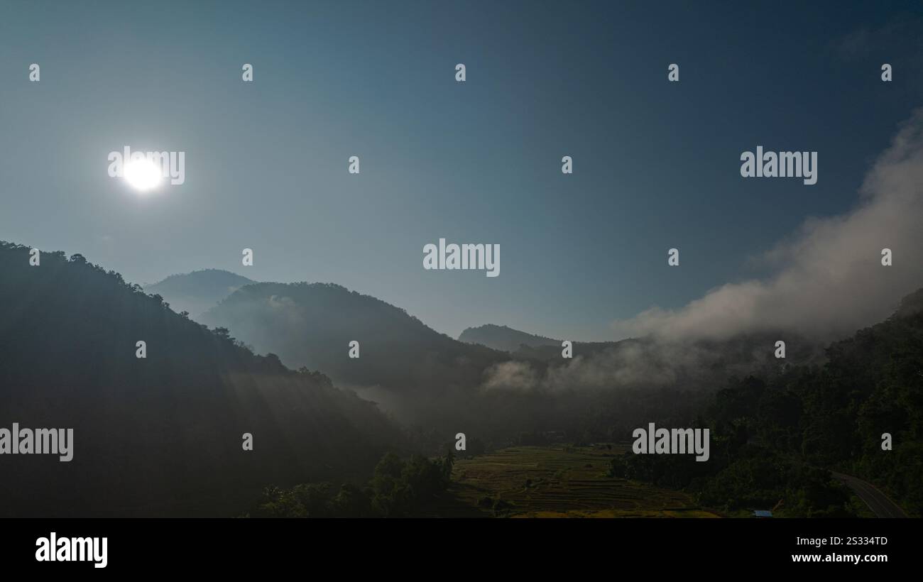 Aerial view of the sun above The sun over the mountain peaks shines ...