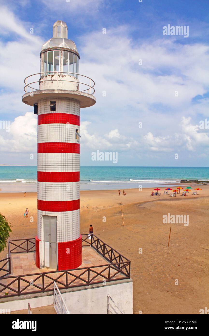 Beach with lighthouse, turquoise sea and sky with clouds Stock Photo ...