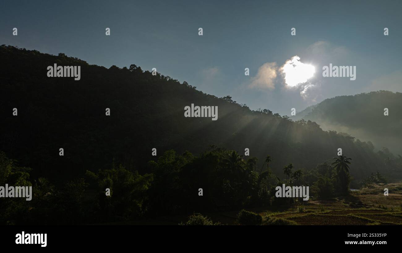 Aerial view of the sun above The sun over the mountain peaks shines ...