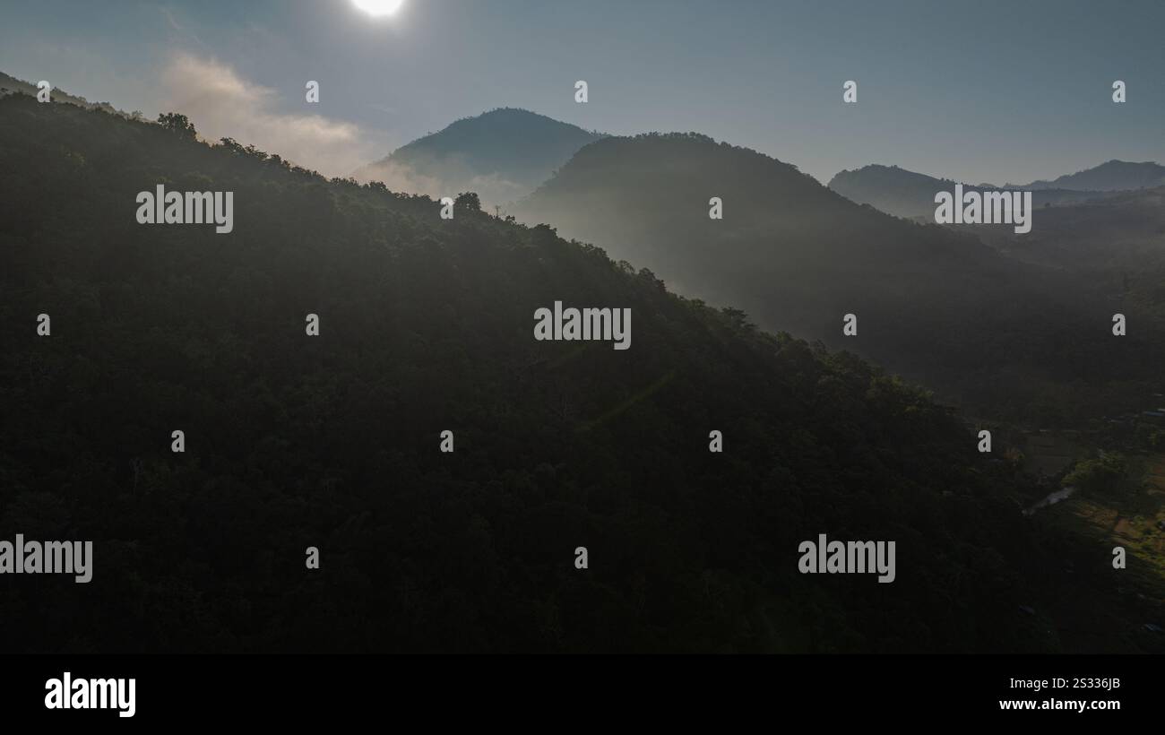 Aerial view of the sun above The sun over the mountain peaks shines ...