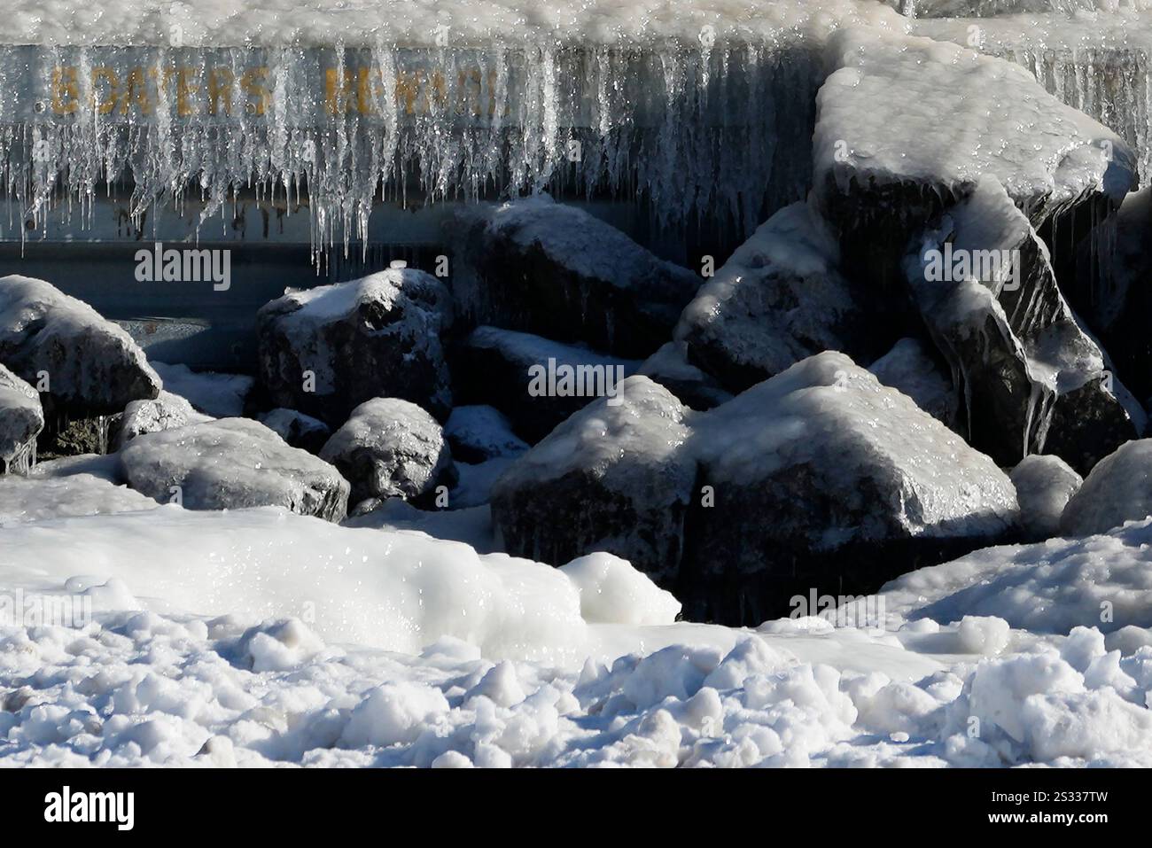 Stones are covered with ice during cold weather in Evanston, Ill ...