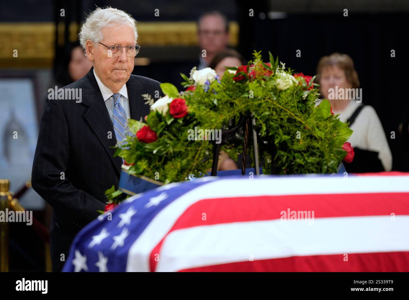 Sen. Mitch McConnell, R-Ky., pauses the flag-draped casket of former ...