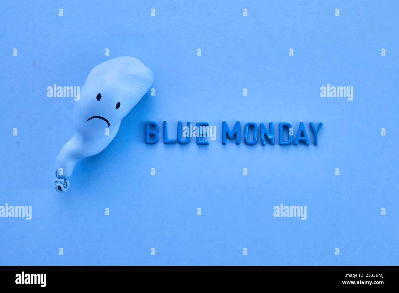 Blue Monday Mood. A deflated balloon with a sad face Stock Photo - Alamy