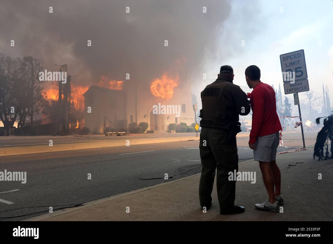 A Los Angeles Sheriff's Deputy, left, talks to a resident as the ...