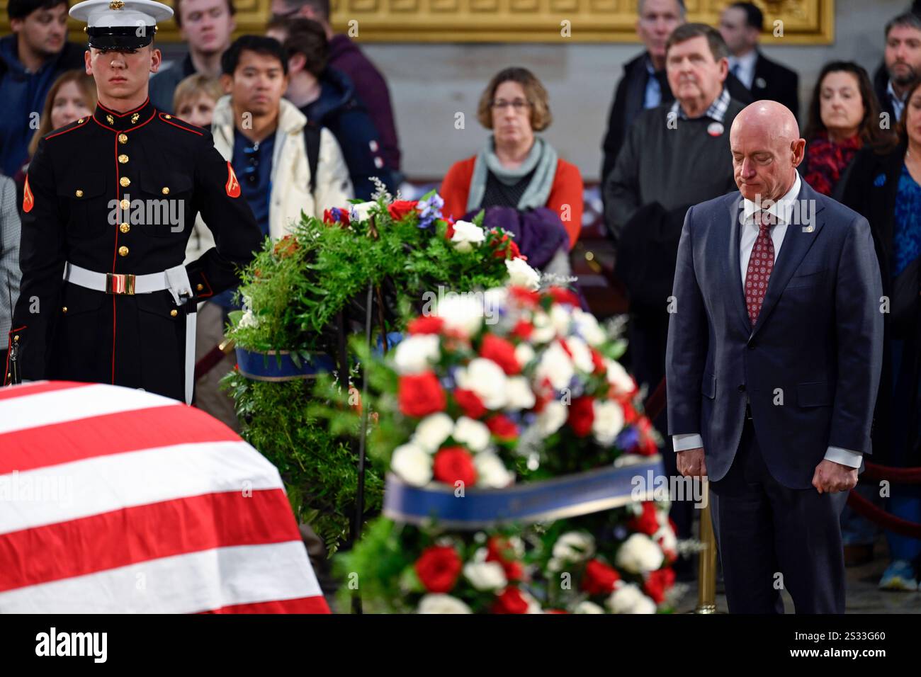 Sen. Mark Kelly, D-Ariz., right, pauses at the flag-draped casket of ...