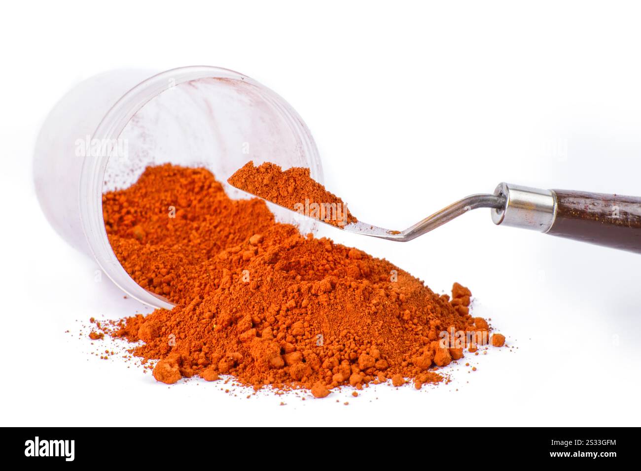 Bright Orange pigment Spice Spilling From Container With Scoop on White ...