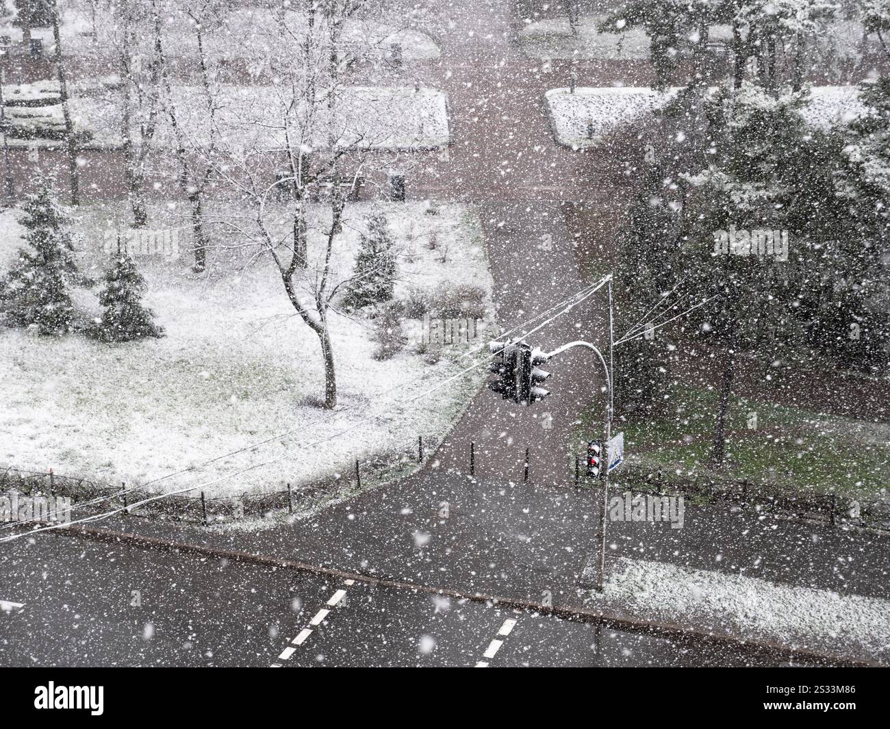 View from the window over heavy fluffy snow falling over the pedestrian ...