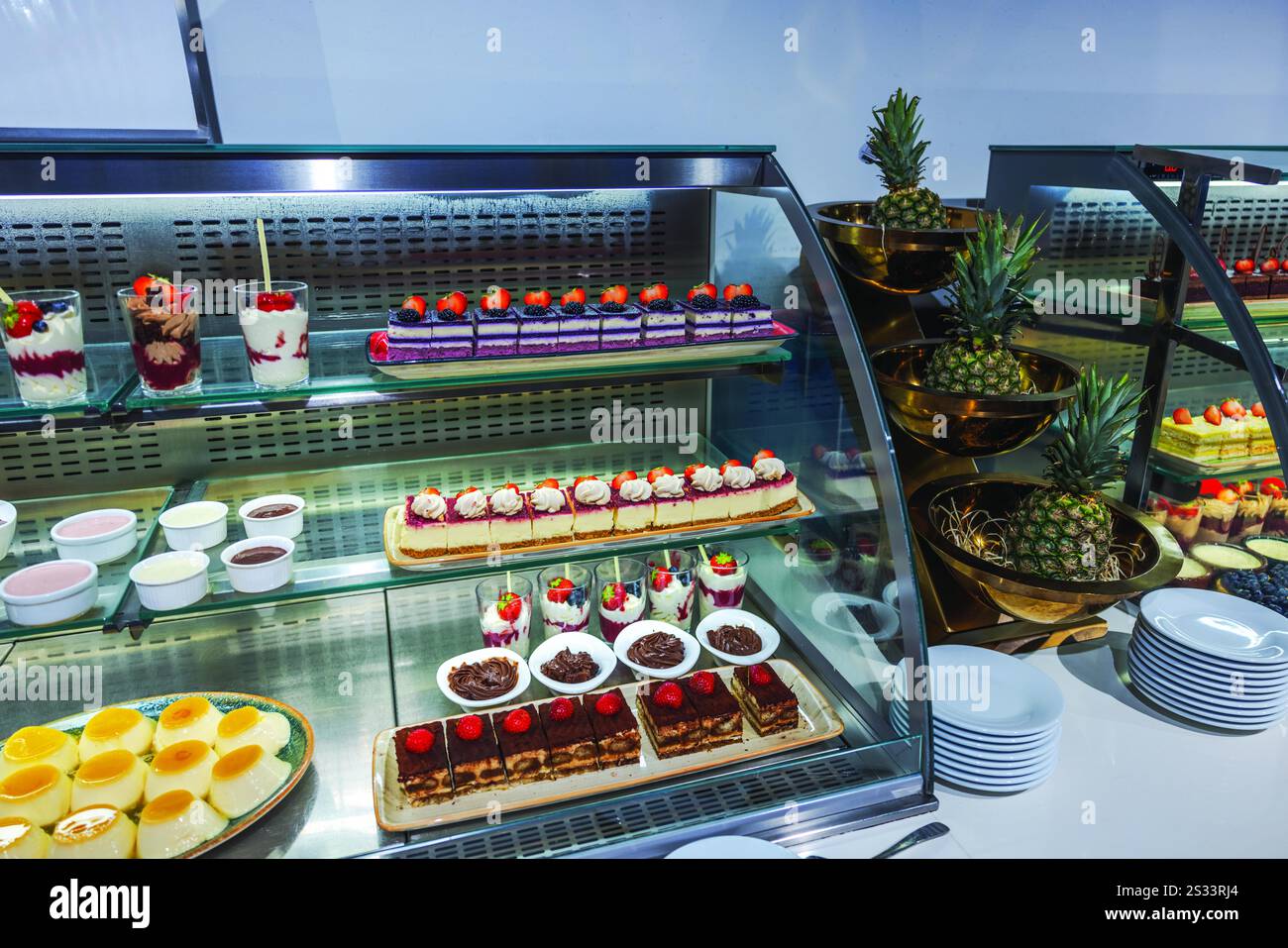 Variety of colorful desserts with strawberries, cream, and pineapple ...