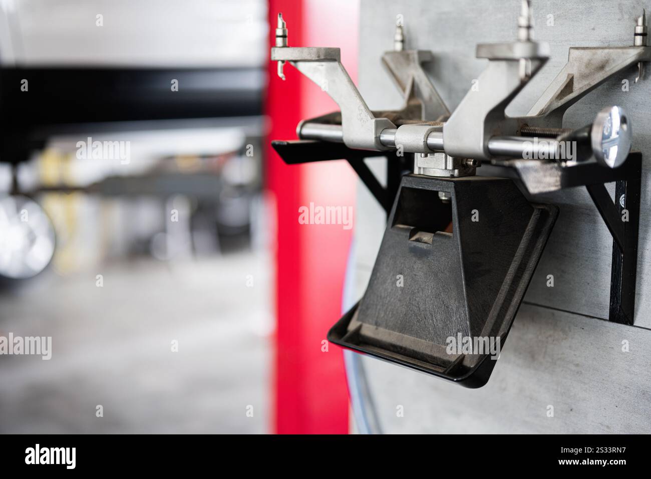 A detailed view of a wheel alignment tool used in an automotive repair ...