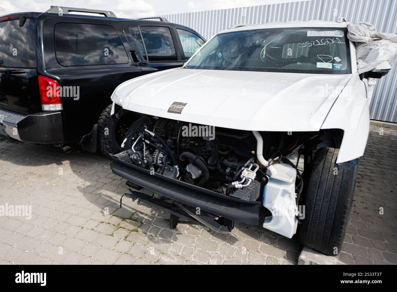 Close-up image of two damaged cars involved in an accident. Shows the ...