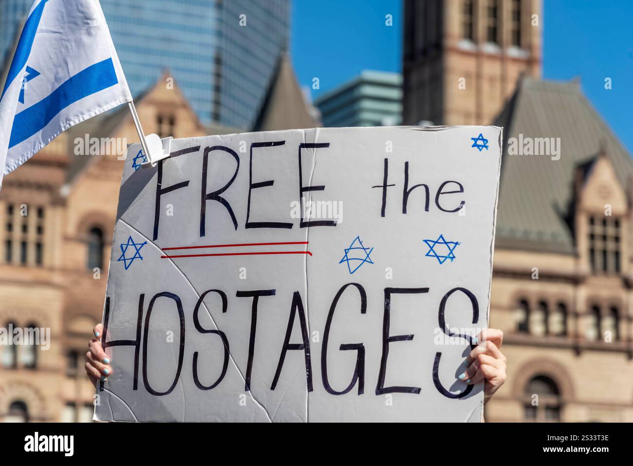 A free the hostages sign at an Israeli rally marking six months of war ...