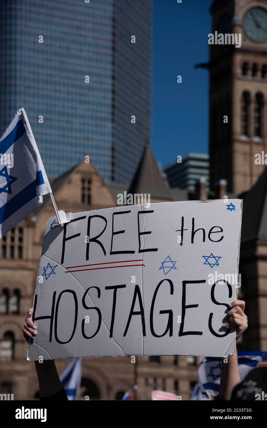 A free the hostages sign at an Israeli rally marking six months of war ...
