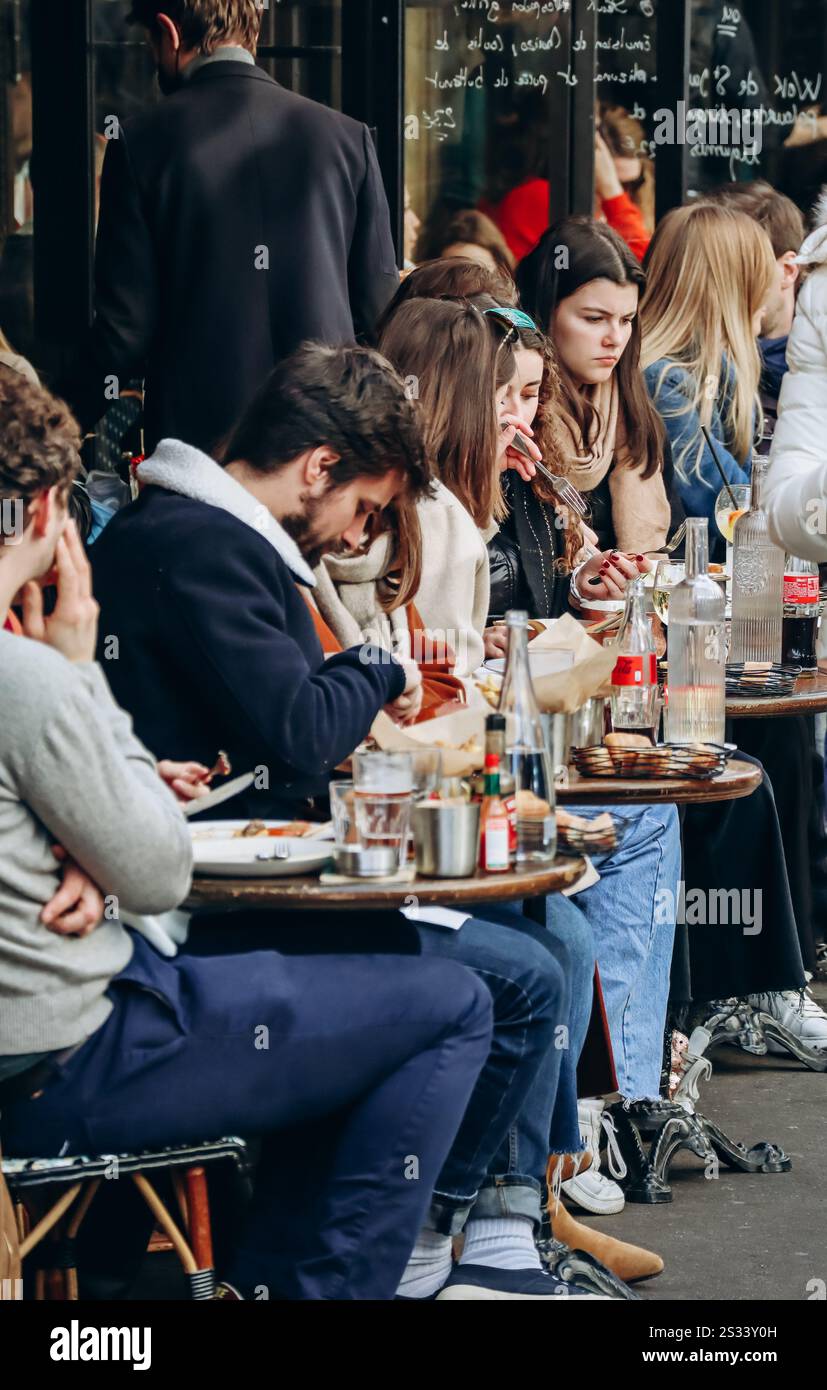 People sitting on a café terrace in Montmartre, Paris Stock Photo - Alamy