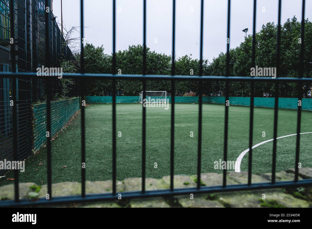 Fenced Sports Field with Goalposts and Surrounding Trees Stock Photo ...