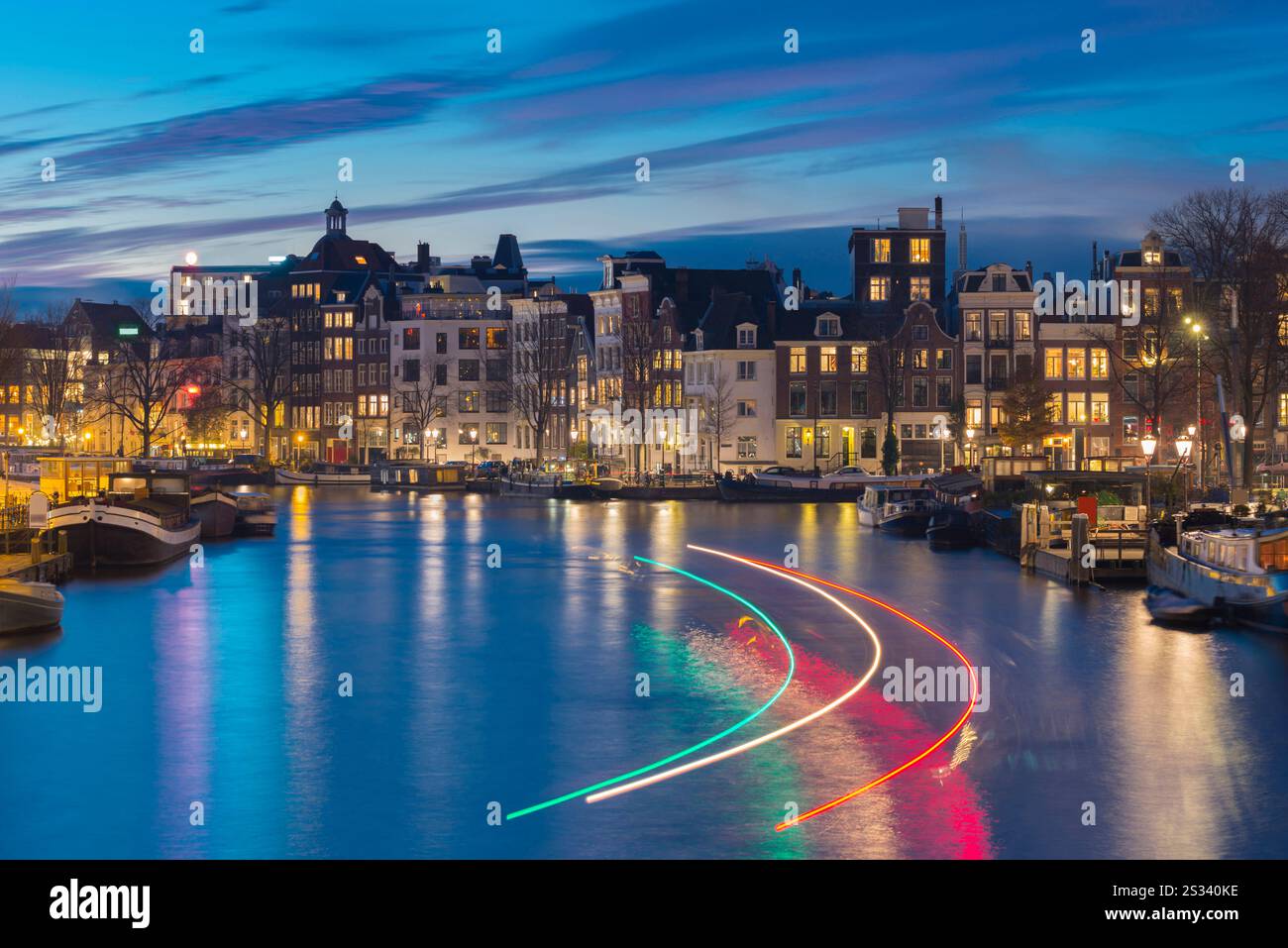 Amsterdam with river Amstel and light rails of canal boat Stock Photo ...