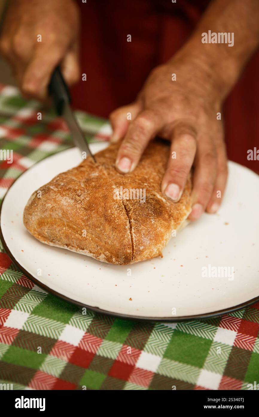 Homemade sourdough bread. Wheat rye flour. Man cuts the bread ...