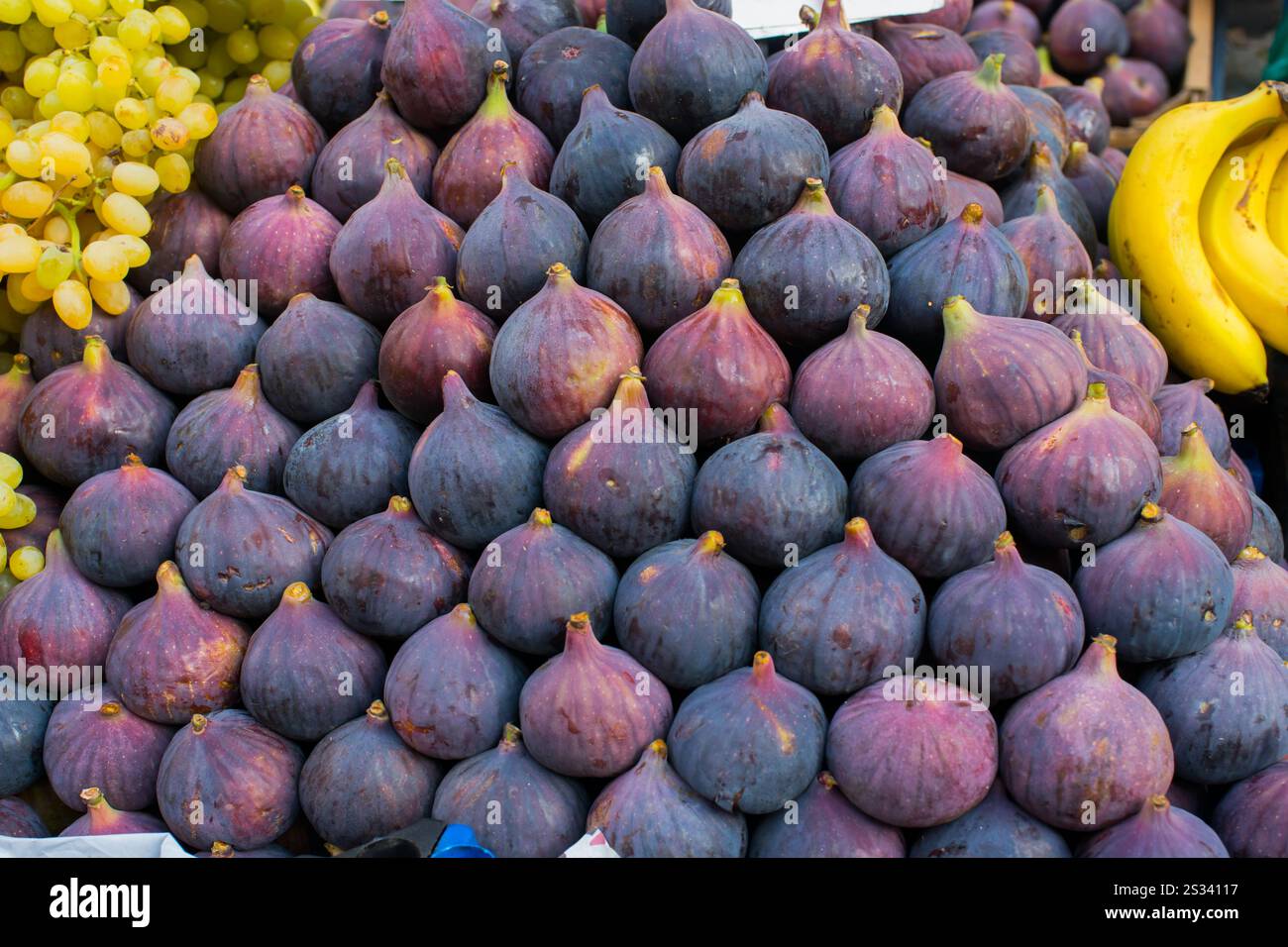Fresh purple figs in a market stall. Figs are delicious seasonal fruits ...