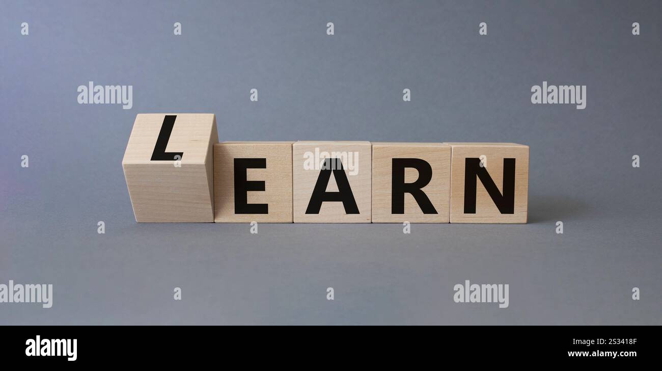 Learn or earn symbol. Turned wooden cubes with words Earn and Learn ...