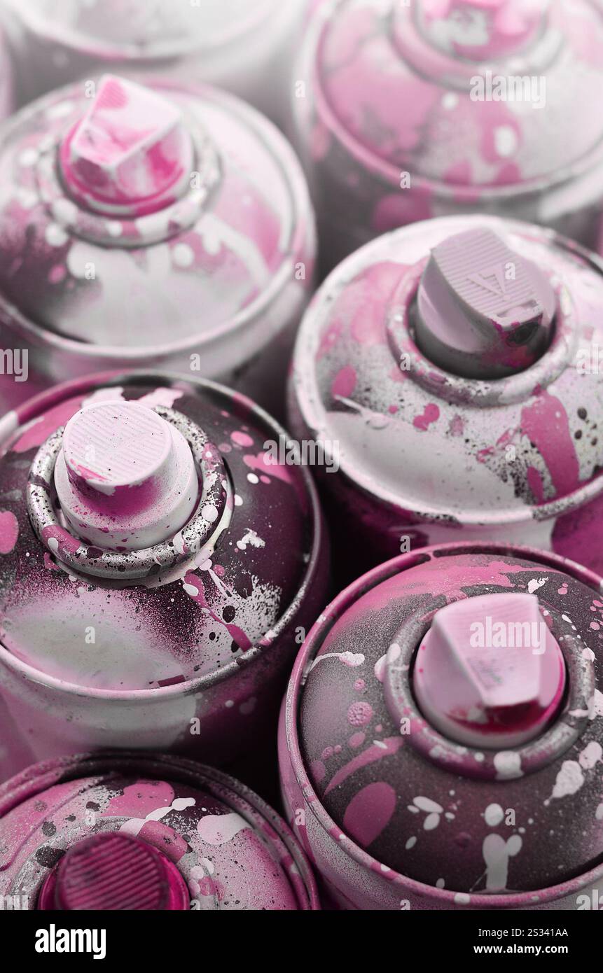 A lot of used spray cans of paint close-up. Dirty and smeared cans for ...
