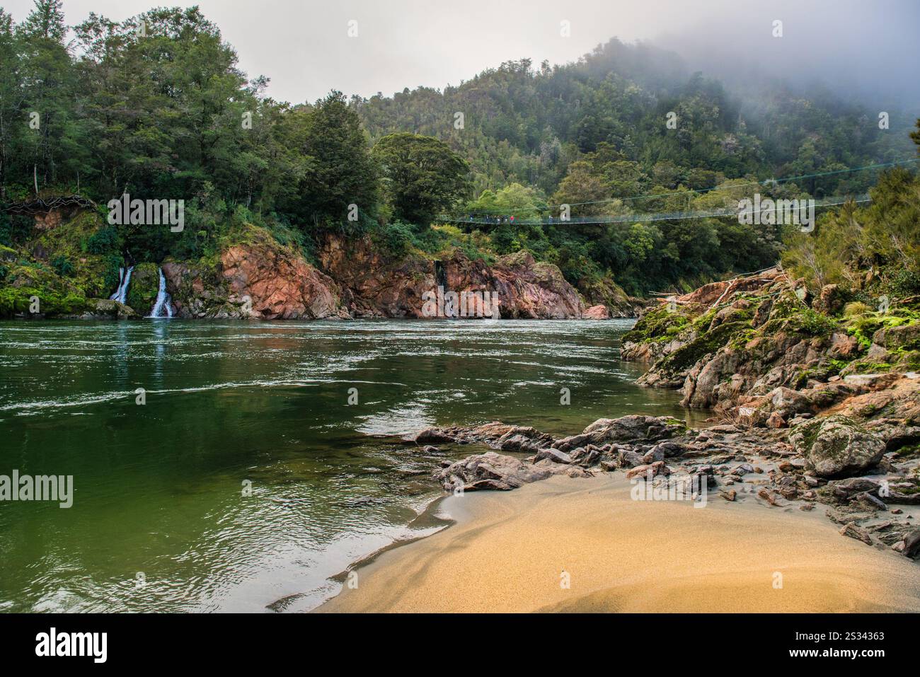 The Buller river flowing through the forest covered upper Buller Gorge ...