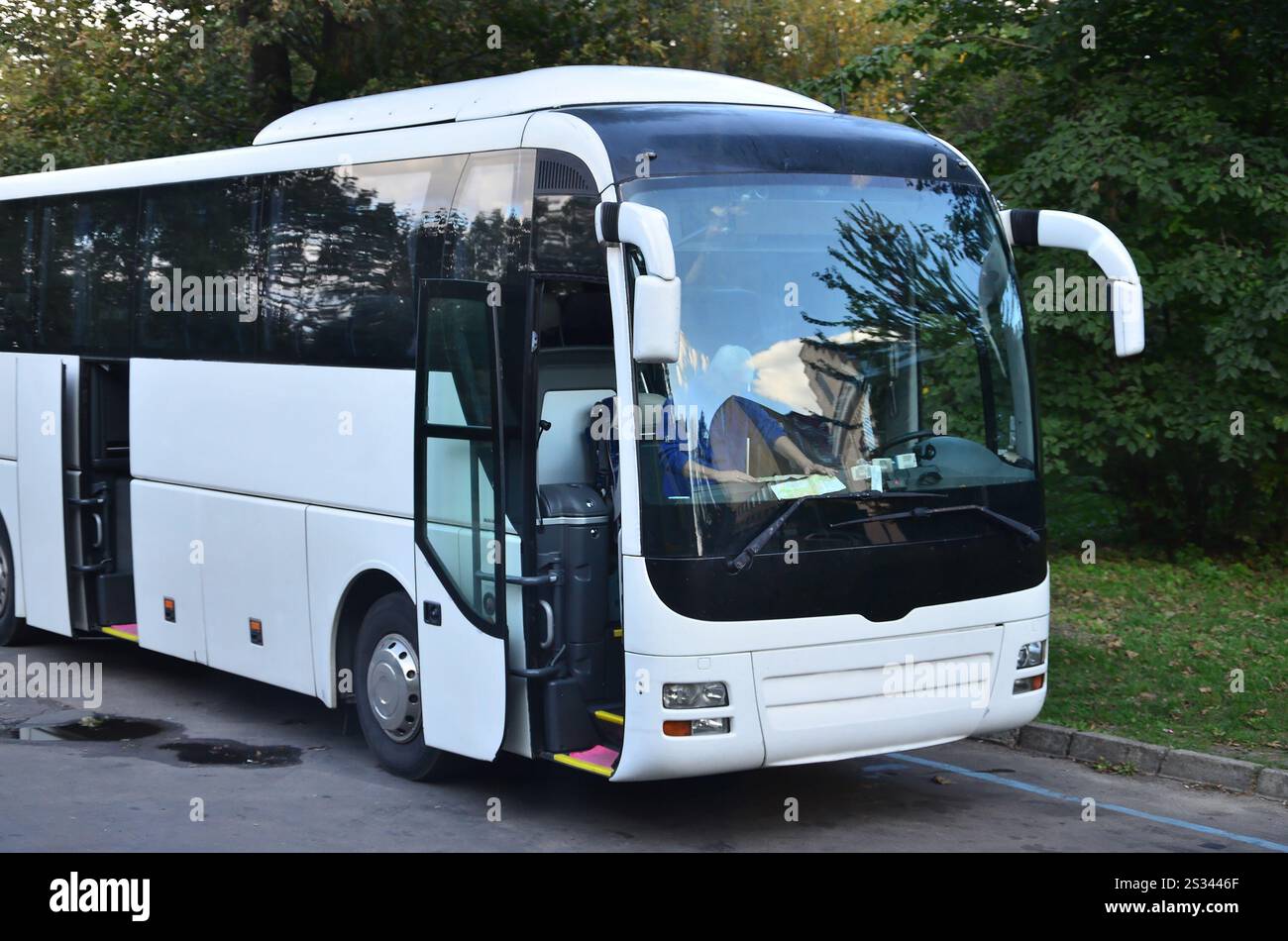 White tourist bus for excursions. The bus is parked in a parking lot ...