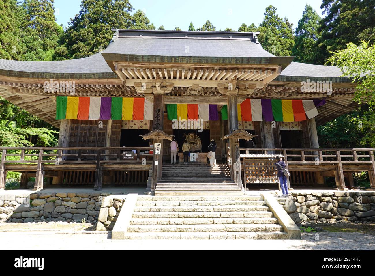 Traditional Japanese Temple with Colorful Banners in Scenic Forest at ...