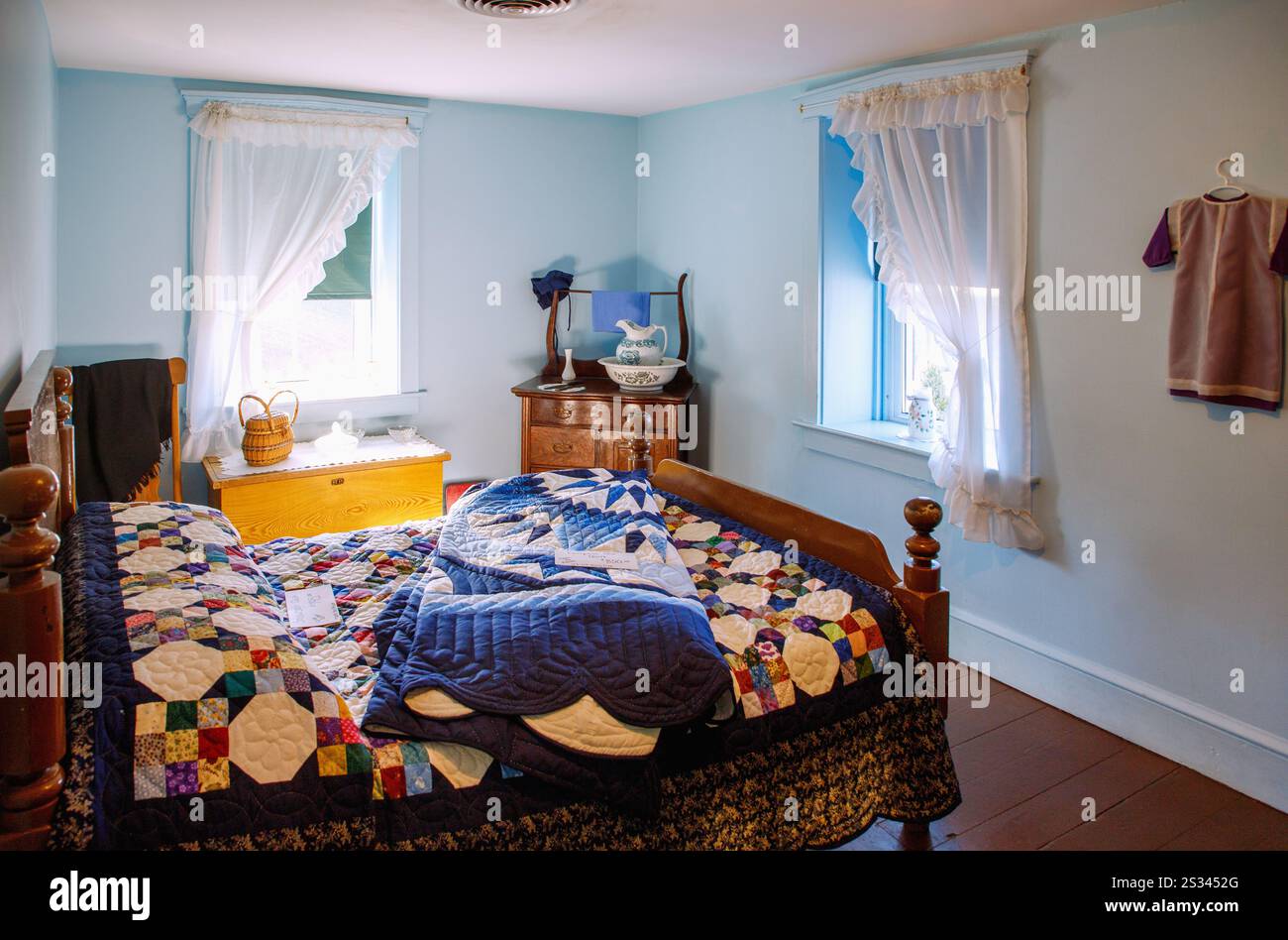 Bedroom with quilts in the Amish House in the Amish Village in the ...