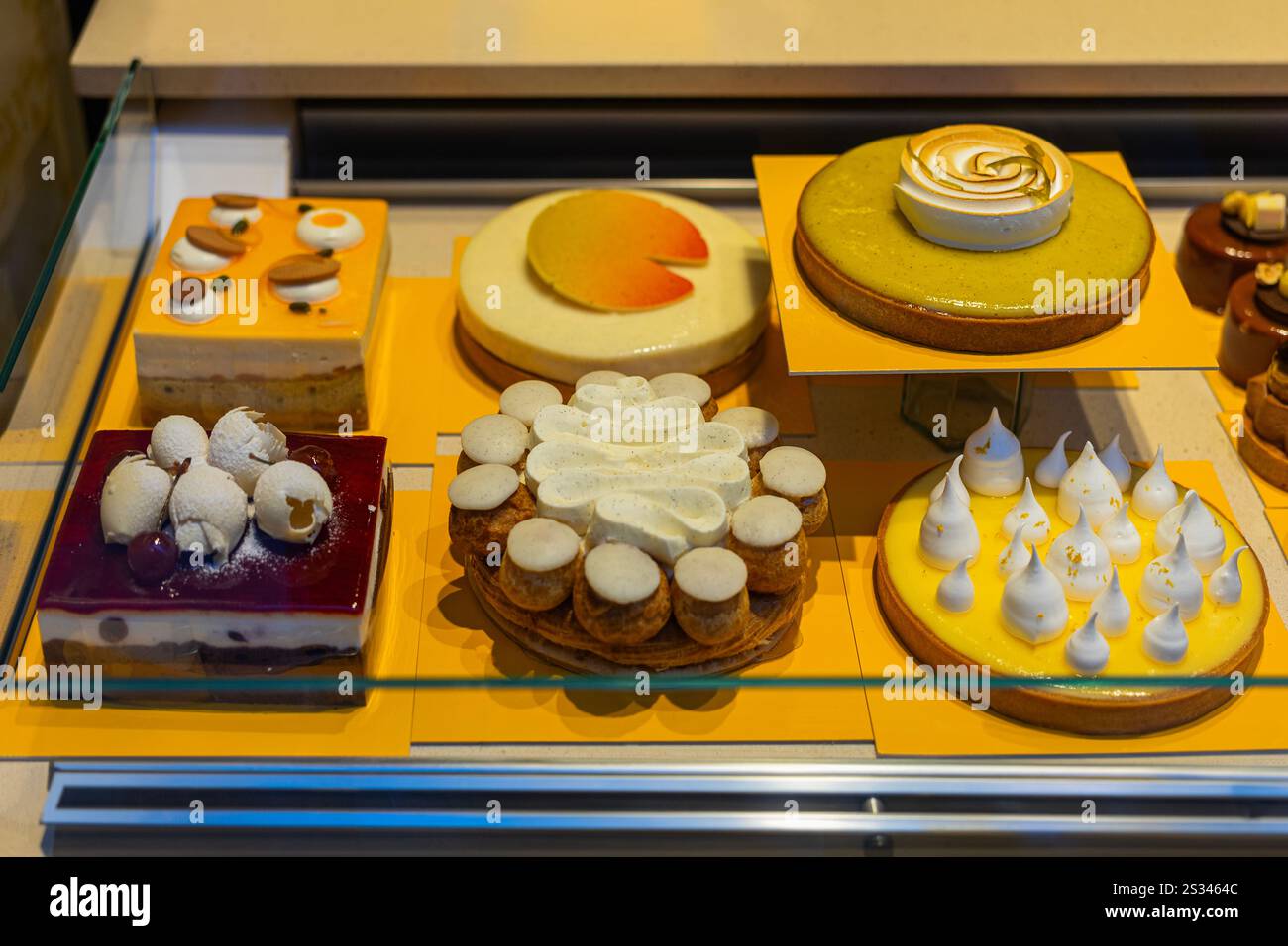 Assortment of cakes displayed in a bakery. Concept of luxury desserts ...