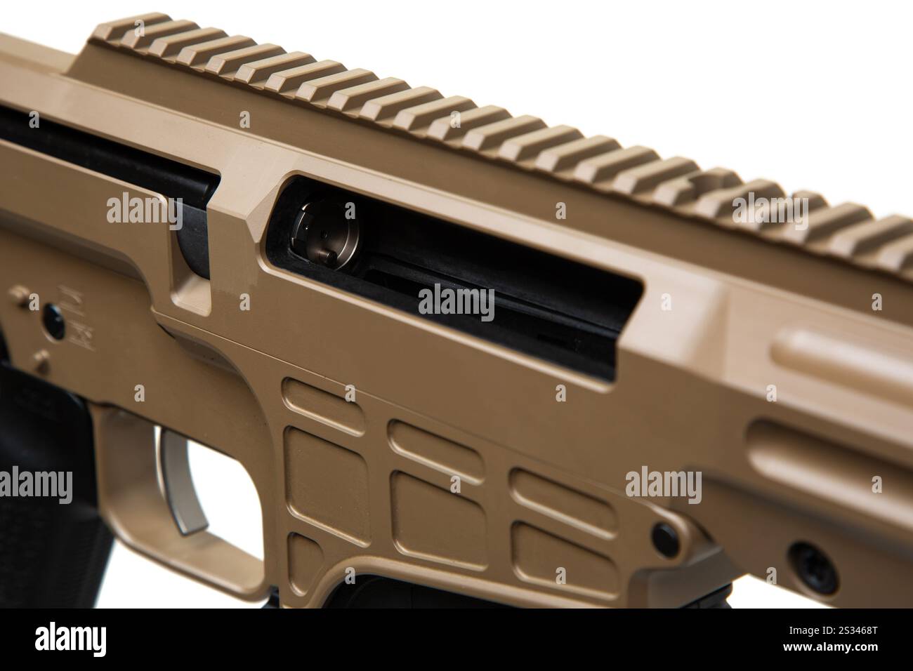 Close-up of a tan-colored rifle's bolt action mechanism, showcasing the ...