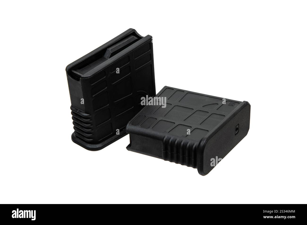 Two black plastic magazines for firearms, one standing upright and the other lying flat ...