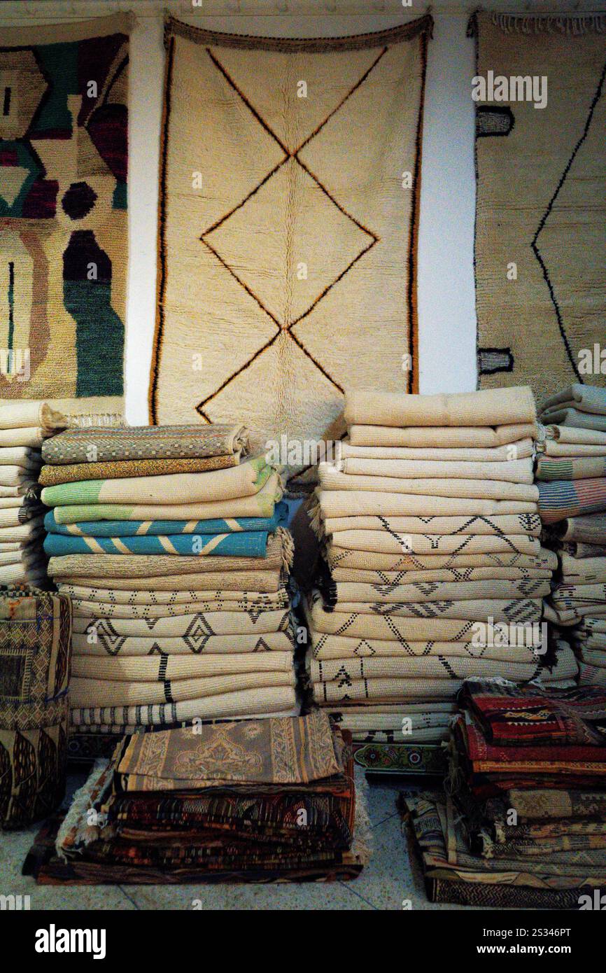 Stacks of handmade Berber rugs for sale in a gallery in Tangier ...