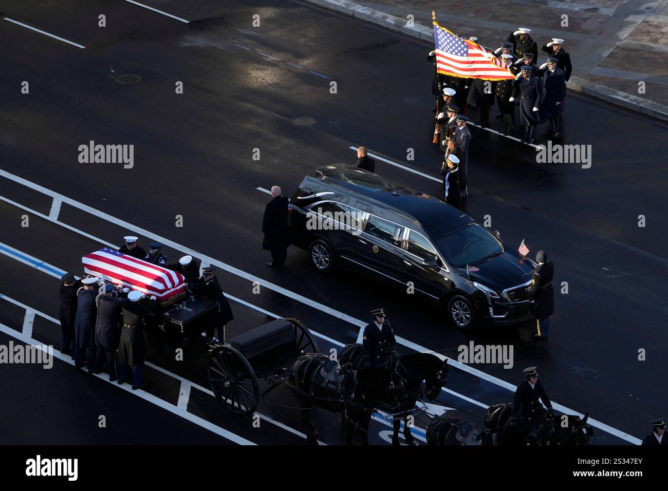 The flag-draped casket of former President Jimmy Carter is transferred ...