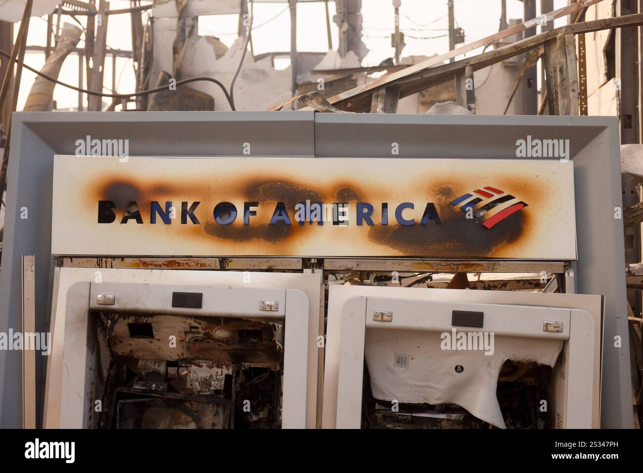 An ATM is damaged at a Bank of America branch after the Palisades Fire ...