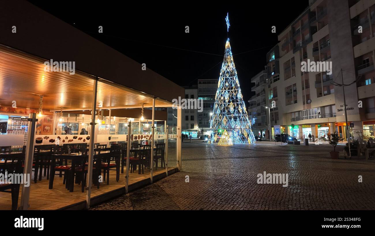 a giant christmas tree, beautifully lit up at night, near santo antonio ...