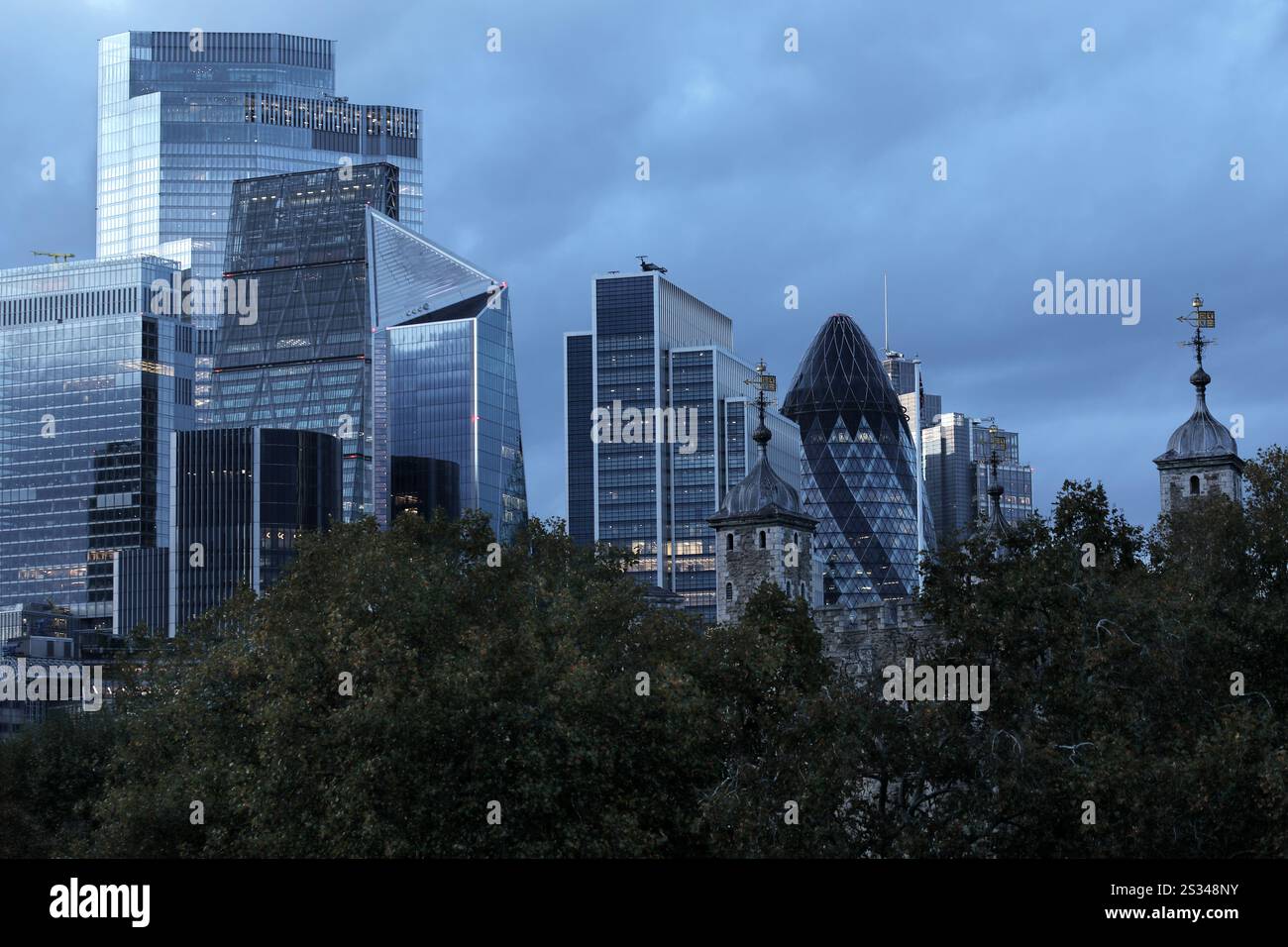 London high rise city buildings and Tower of London beyond trees. A ...