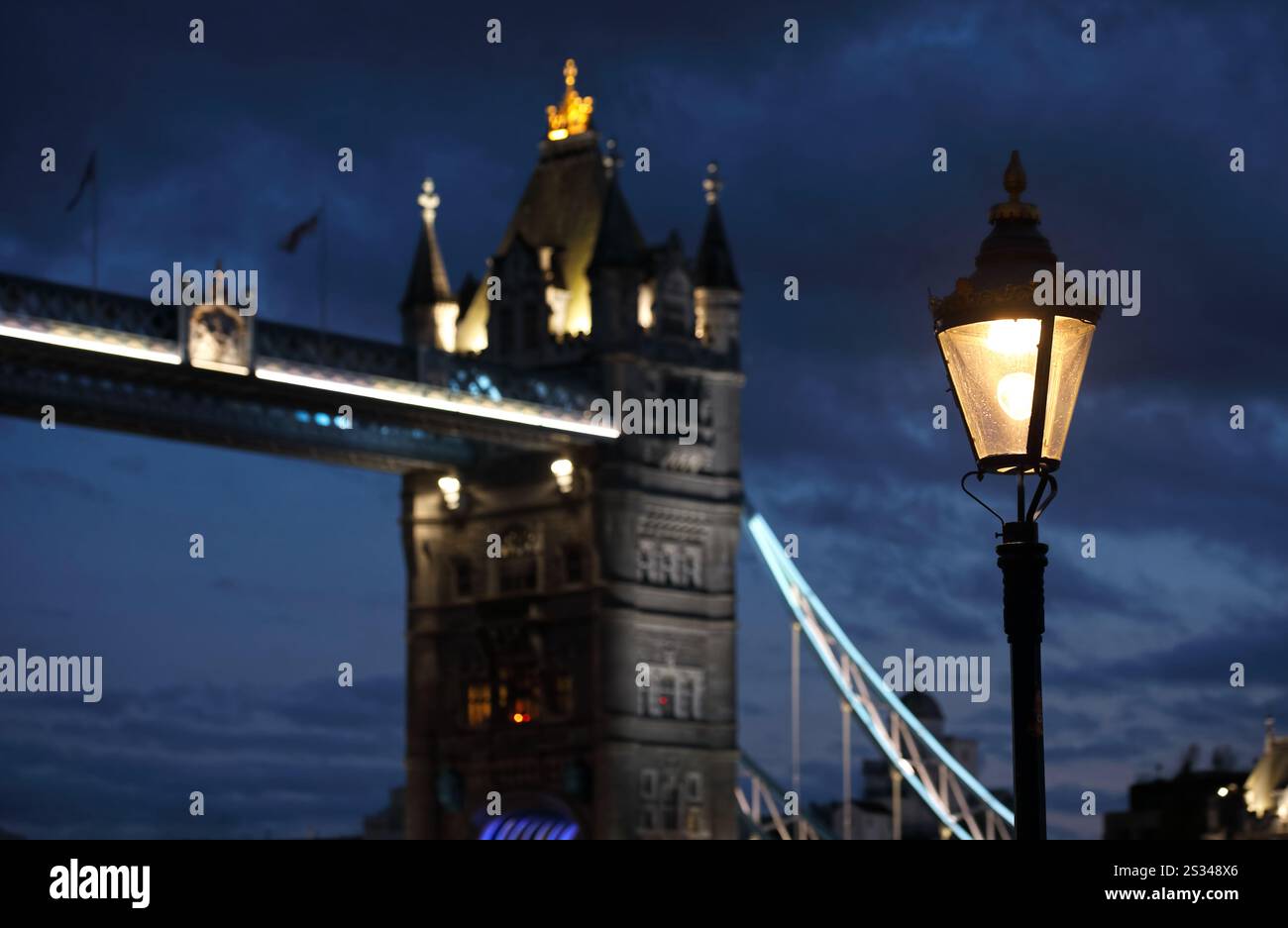 London Tower Bridge illuminated at night in background. Focus is on an ...