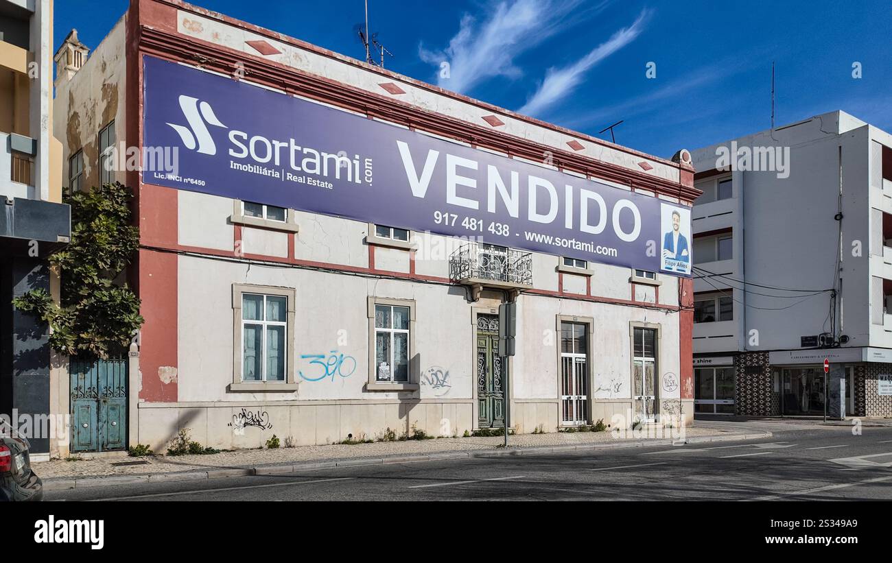 An old commercial building in Faro, Portugal, with a 'Vendido' (sold ...