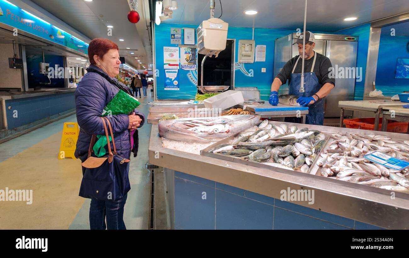 Local residents browse fresh produce inside the Faro Municipal Market ...