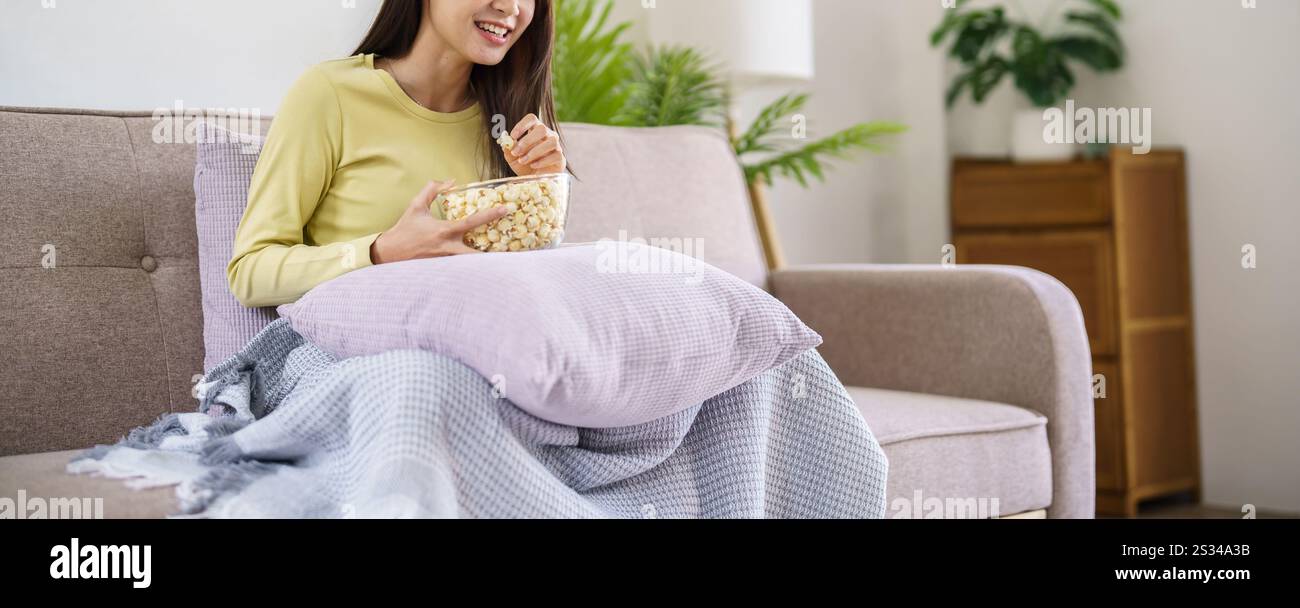 Asian woman Watching smart TV and using remote controller Hand holding ...