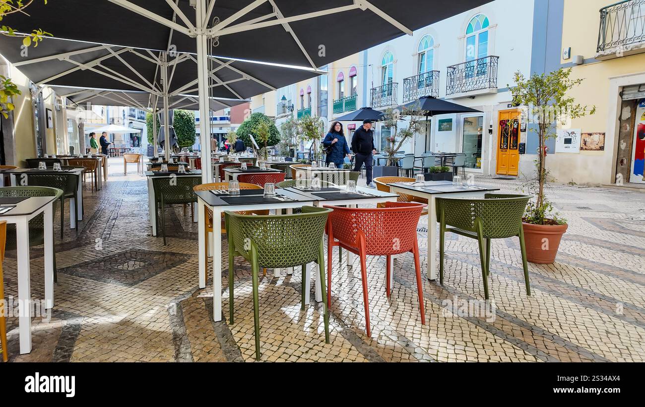 Empty restaurant patio tables on a normally busy shopping street in ...