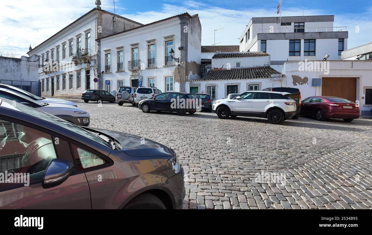 Cars parked randomly on the street in the old town of Faro, Portugal ...