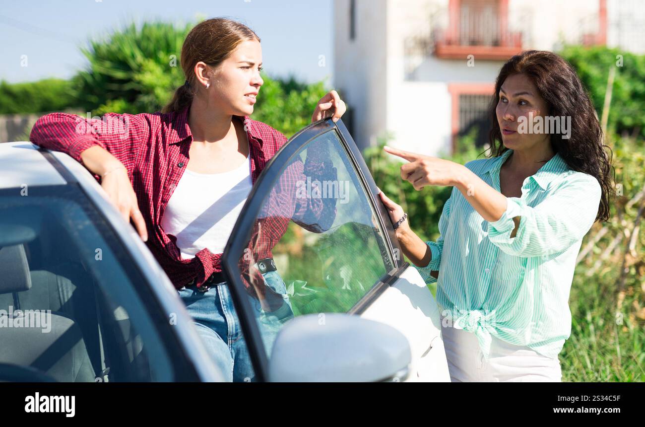 Woman showing way to young lady Stock Photo - Alamy