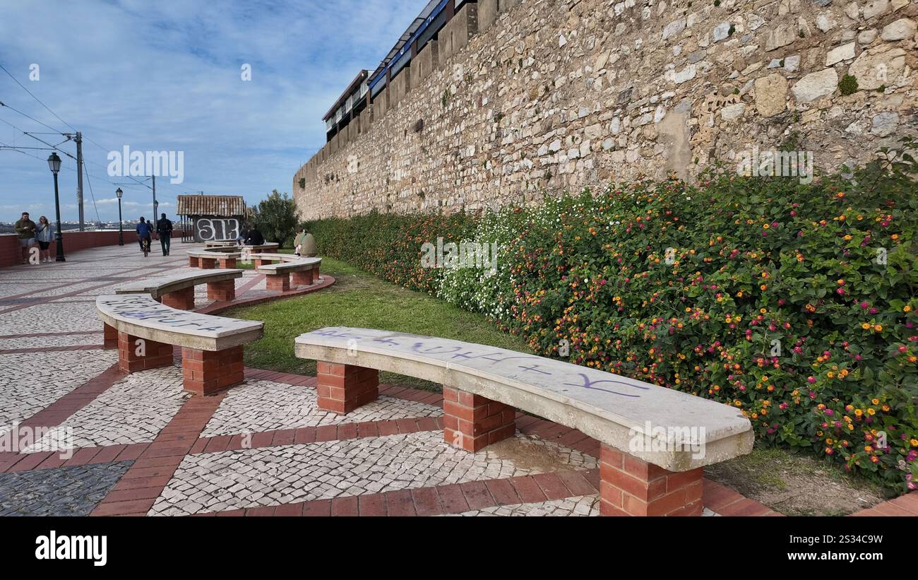 Outdoor benches by the waterfront in Faro, Portugal, with the city ...