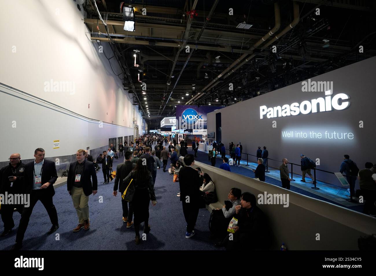 People walk near a Panasonic booth at the CES tech show Wednesday, Jan ...